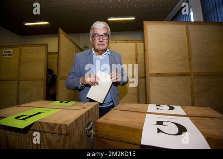 Andre Peeters casts his vote at a polling station in Aarschot, Sunday ...