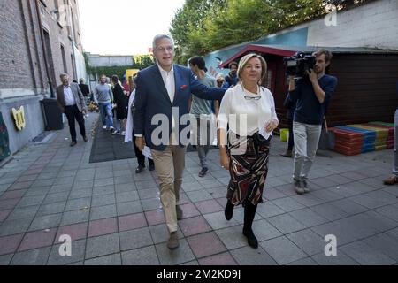 Kris Peeters and his wife Ann cast their vote at a polling station in ...