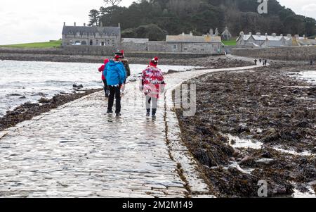 People walk along the causeway out to Saint Michael's Mount in Marazion ...