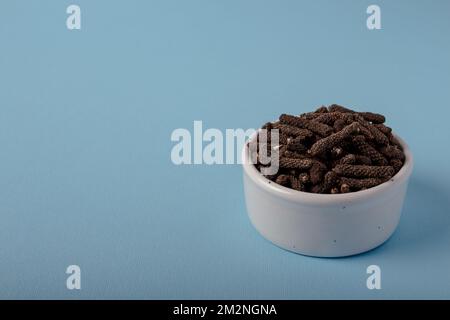 Dry Indian long pepper in white bowl. Piper Longum ,Piper retrofractum ...