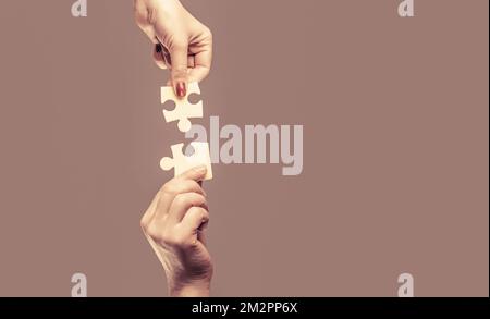 Hands hold puzzles. Solution of problems. Mens and childs hands ...