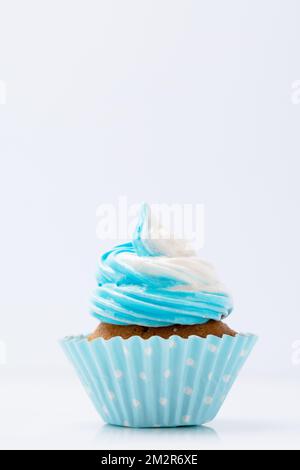 Blue cupcake on grey background with copy space Stock Photo - Alamy