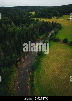A vertical aerial view of the Amata river and green nature in Latvia ...