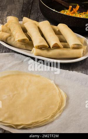 Making homemade spring rolls. White dish on a wooden background Stock ...