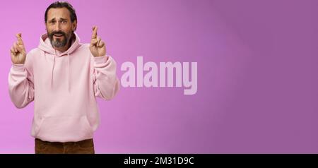 Nervous unsure hopeful handsome bearded 40s man in pink stylish hoodie ...