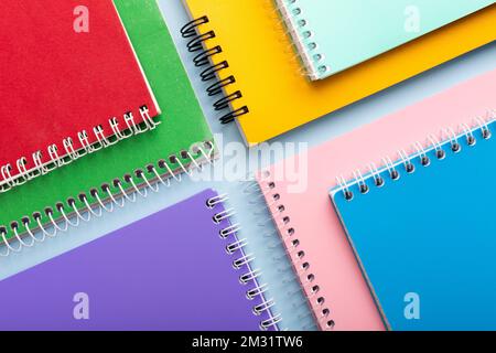 colored notebooks, colored pencils on a light table. Place for your ...