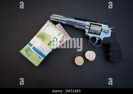 next to a wad of cash and a stack of Krugerrand gold coins lies a ...