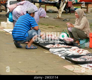 An indigenous Bajau woman selling fish and seafood at the Sunday market ...