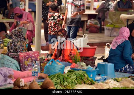 Indigenous Bajau women selling food at the Sunday market (tamu) in Kota ...