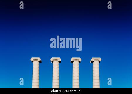 Four classical ionic columns, isolated on blue sky background Stock ...