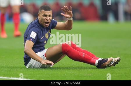 Kylian MBAPPE (FRA) on the ground, working on a torn shoelace from his ...