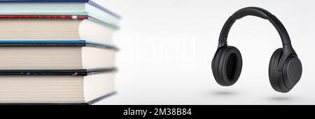 Audiobook concept. Stack of books and headphones on white background ...