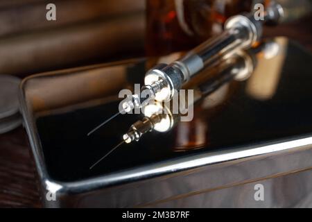 Antique syringe on a wooden table Stock Photo - Alamy