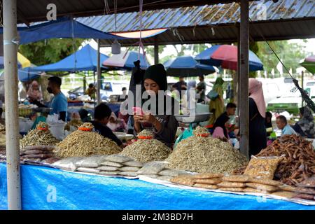 An indigenous Bajau woman selling food at the Sunday market in Kota ...