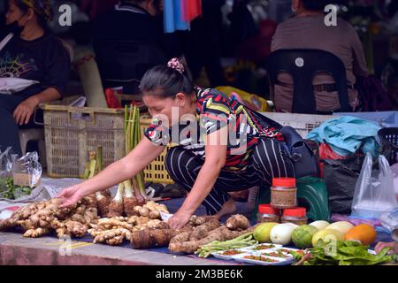 An indigenous Bajau woman selling food at the Sunday market in Kota ...