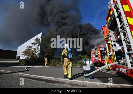 Firefighters pictured at the scene of a fire in an apartment building ...