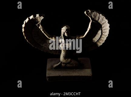 Closeup to a Isis. female old winged egyptian god mini figurine ...