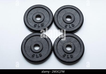 Closeup to a dumbbell disc over white background. Ideal for fitness ...