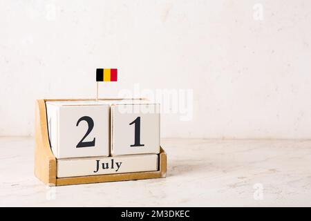 Cube calendar and small Belgian flag on table near light wall Stock ...