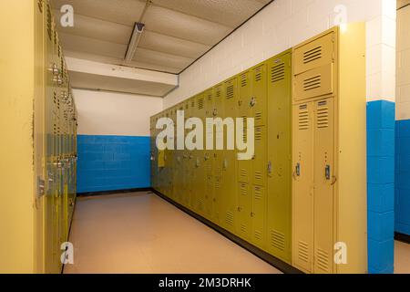 Nondescript locker room with old yellow and green metal gym, gymnasium ...
