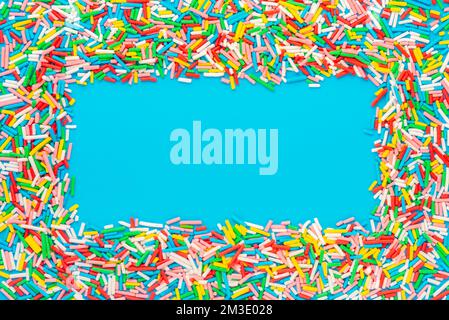 greeting wreath of colorful sprinkles blue background, festive ...
