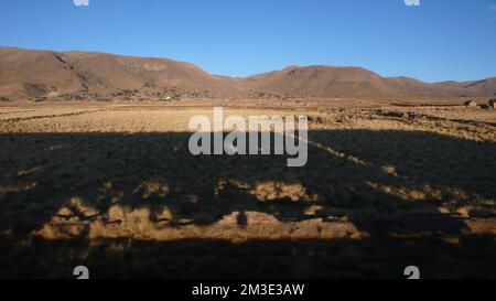 Shadow of a driving Train in Desert blue sky mountains Stock Photo - Alamy