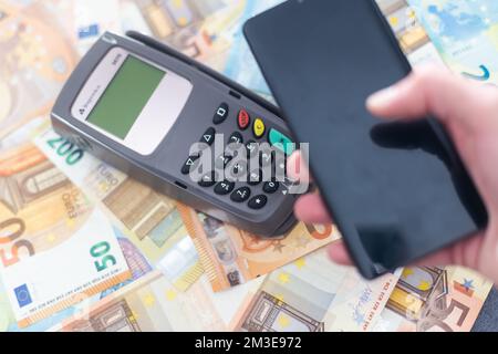 Banking terminal on euro banknotes background close up Stock Photo - Alamy