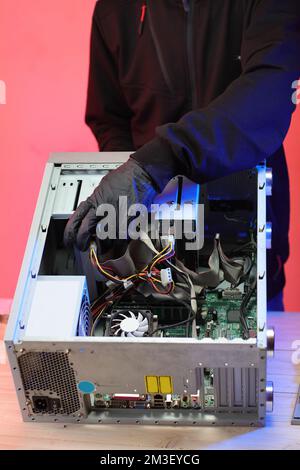 disassembly of an old desktop computer on a table and a pink background ...
