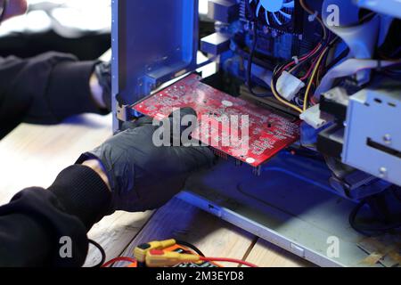 inserting an old graphics card into a computer on the table Stock Photo ...