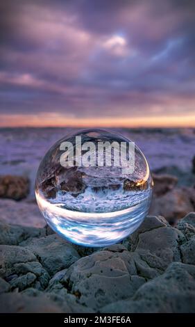 transparent lens ball in a sea ocean landscape background. trasparent ...