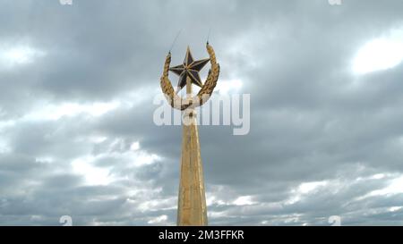 Drone shot of the spire of a high rise building with a golden five ...