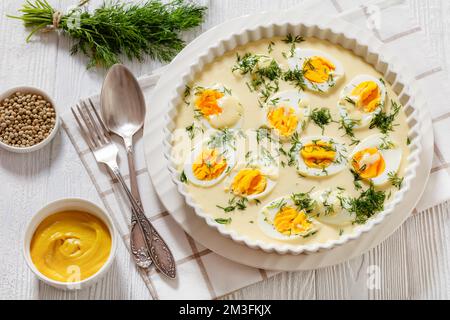 Senfeier, hard boiled eggs in rich creamy mustard sauce in white baking ...