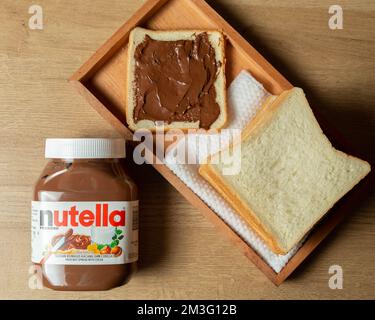 Nutella with large and small bottles and some white bread neatly ...