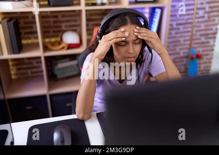 African american woman streamer stressed using computer at gaming room ...