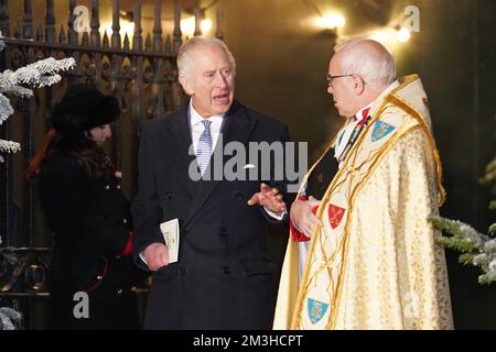 King Charles III talking to Dean of Westminster David Hoyle followed by ...