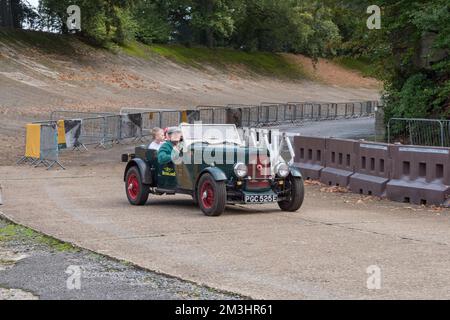 A vintage MG car driving around the historic Brooklands banked track at ...