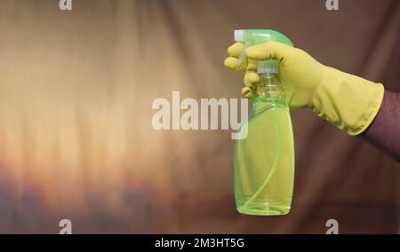 Cleaning dirty surfaces with a cleaning agent. Hand in a rubber glove ...