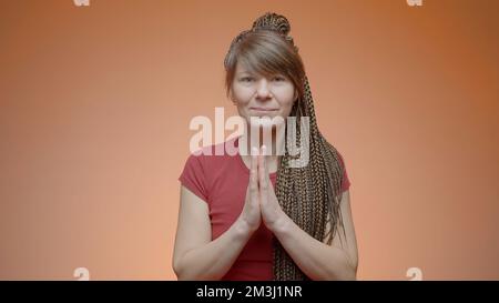 Woman greets with folded hands. Action. Yoga greeting with gratitude ...