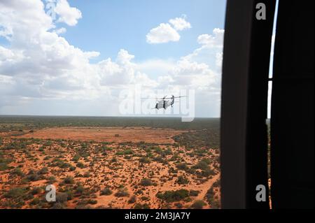 A HH-60W combat rescue helicopter follows behind its wingman in support ...