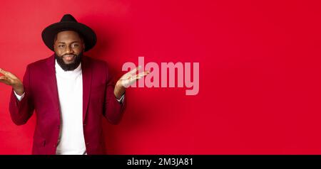 Clueless and unbothered Black man shrugging with indifferent look, dont ...