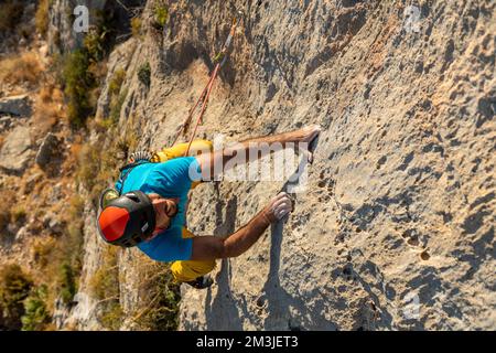 Man climbing a wall near Bolulla village, Alicante., Spain Stock Photo ...