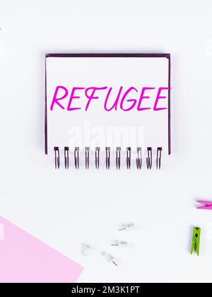 Hand writing sign Refugee. Word for refer to movements of large groups ...
