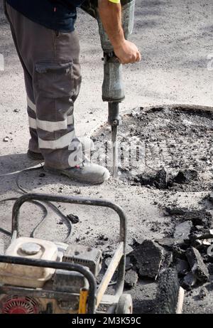 hydraulic hammer in the hands of an operator in uniform works the ...