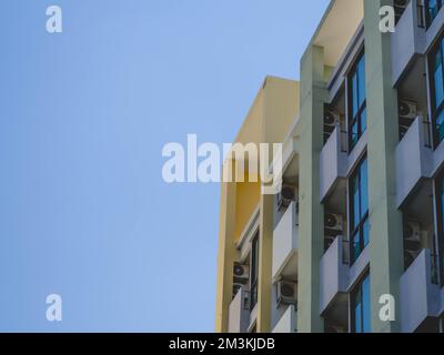 Yellow tall condos and sky Stock Photo - Alamy