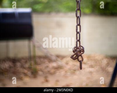 Hanging iron chains against natural background Stock Photo - Alamy
