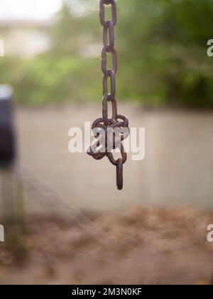 Hanging iron chains against natural background Stock Photo - Alamy