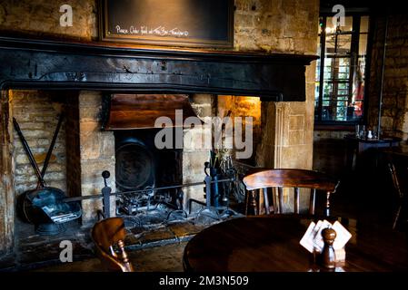 An inglenook fireplace in an English country cottage, decorated at ...