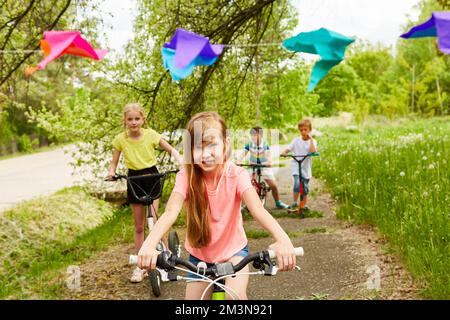 Friends cycling in park during sunny day Stock Photo - Alamy