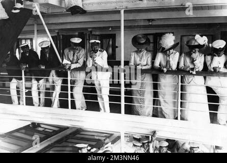 King George V on board his yacht at Cowes. At the wheel is Major ...