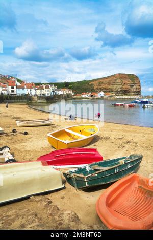Staithes harbour, beach and cliffs from beach at high tide. North ...